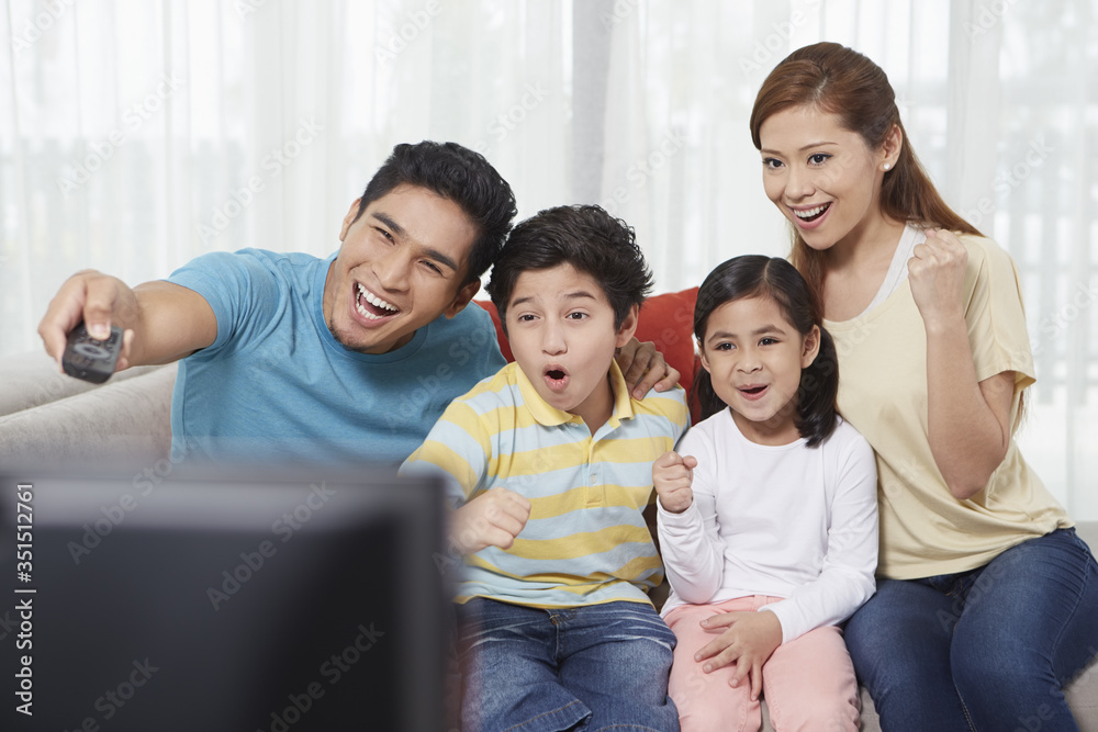 Parents and children watching television Stock Photo | Adobe Stock