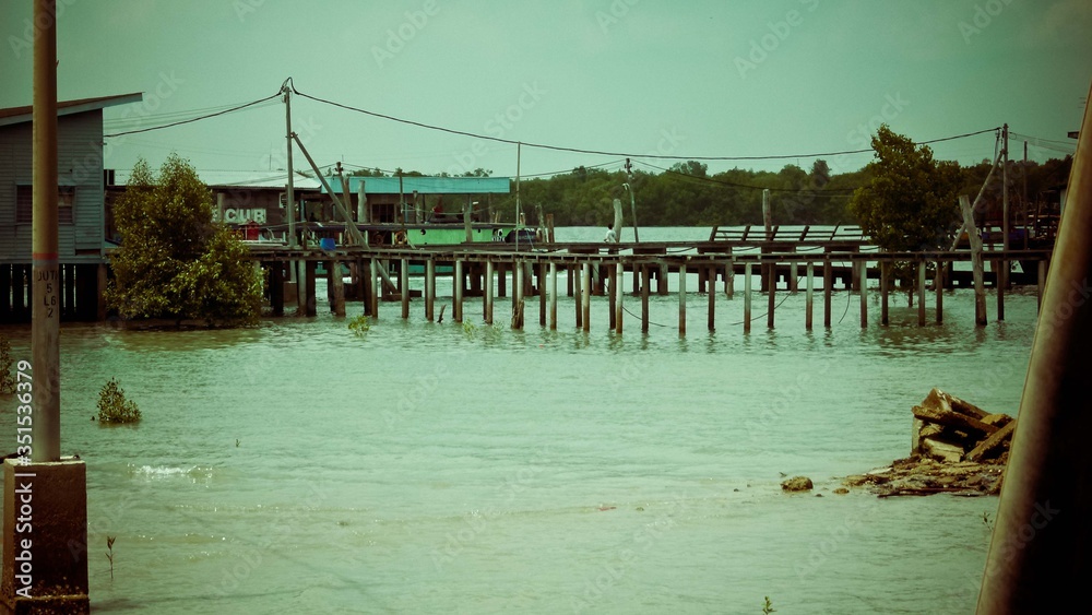 Long dock of bridge with rows of poles Stock Photo | Adobe Stock