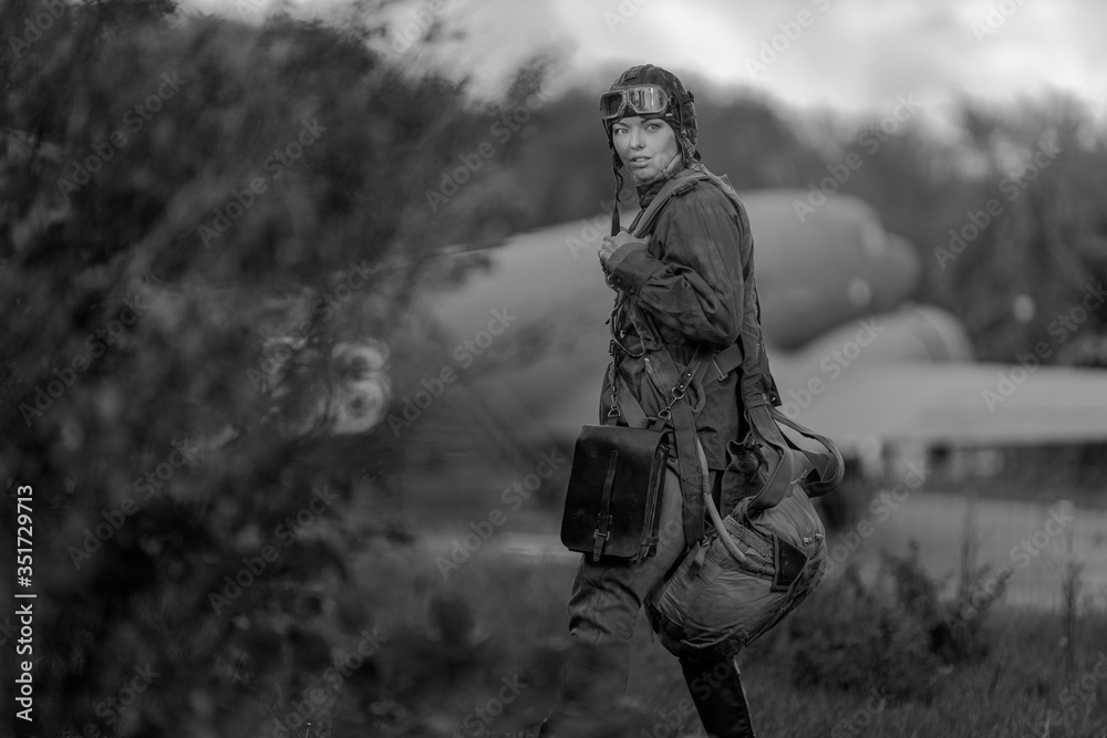 Retro style black and white. A young female pilot in uniform of Soviet ...