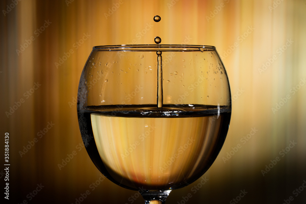 Water splash. Reaction of a falling drop on a cold water surface inside ...