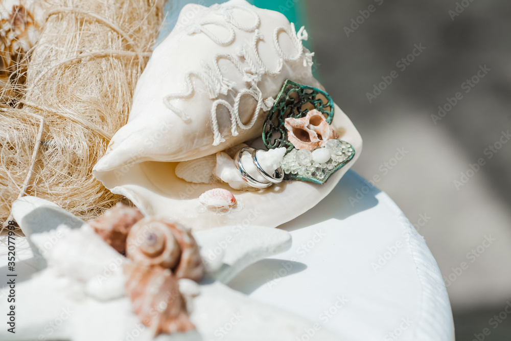 Wedding rings close up decorated nautical with accessories for tropical ...