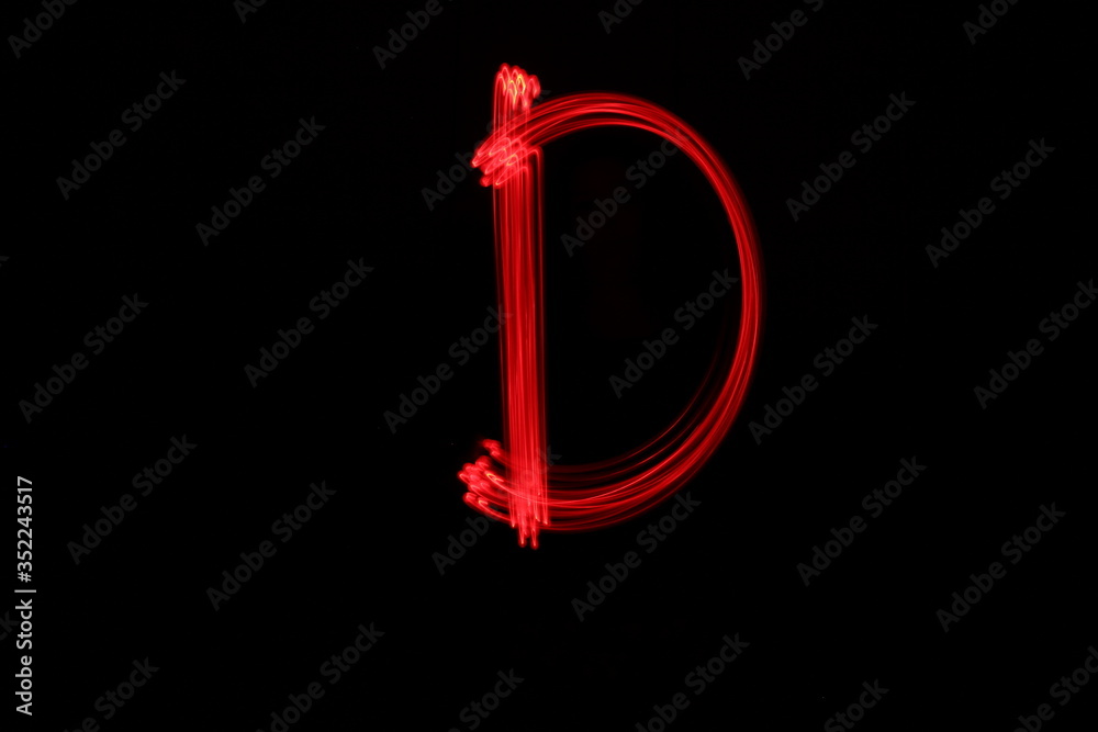Long exposure photograph of the letter d in neon red colour fairy ...