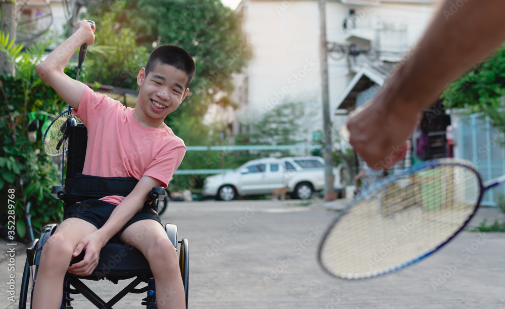 Asian special child on wheelchair is playing badminton to strengthen ...