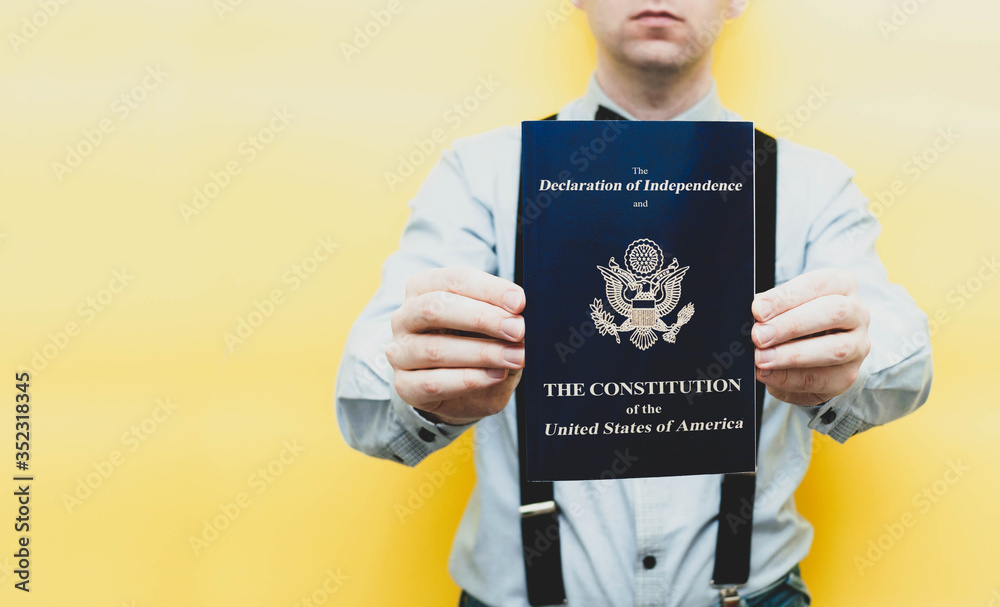 cropped view of man in shirt holding blue brochure with usa ...