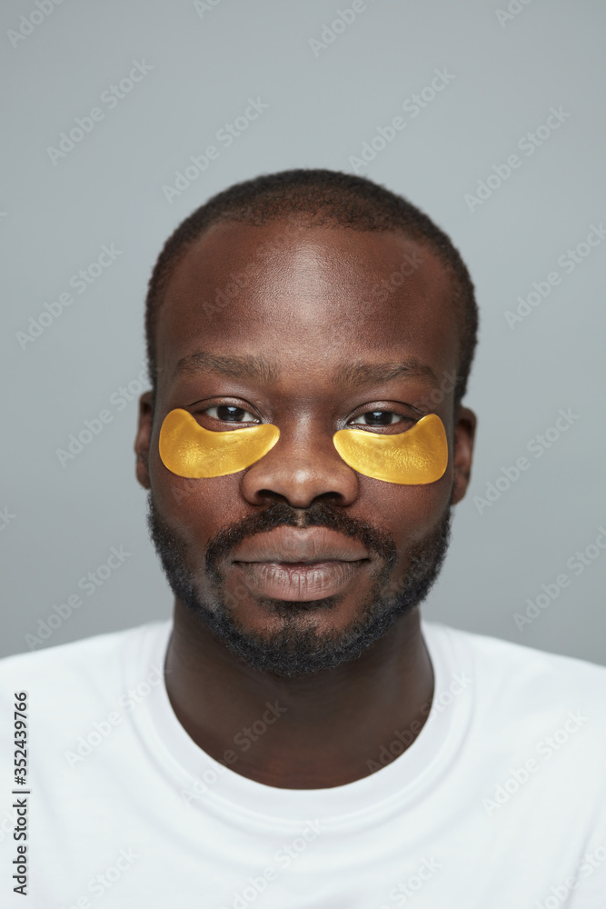 Skin Care. Portrait Of Male Model Applying Yellow Under Eye Patches ...
