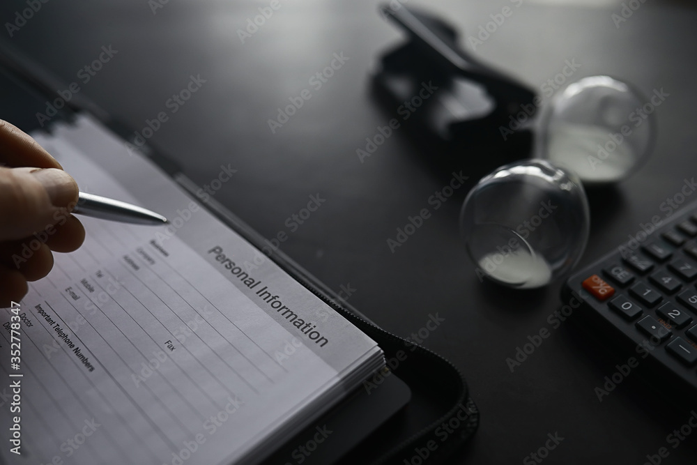 Foto de Stock Filling out a form with personal information. Documents ...