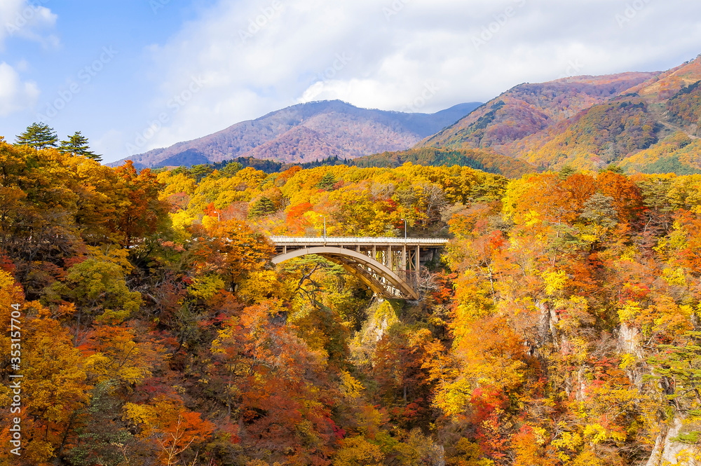 View of a bridge in crossing the Naruko Gorge near Sendai, Miyagi, Japan with trees with autumn ...