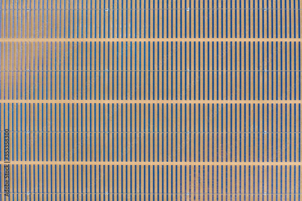 Vertical aerial view of a photovoltaic solar panel farm producing ...