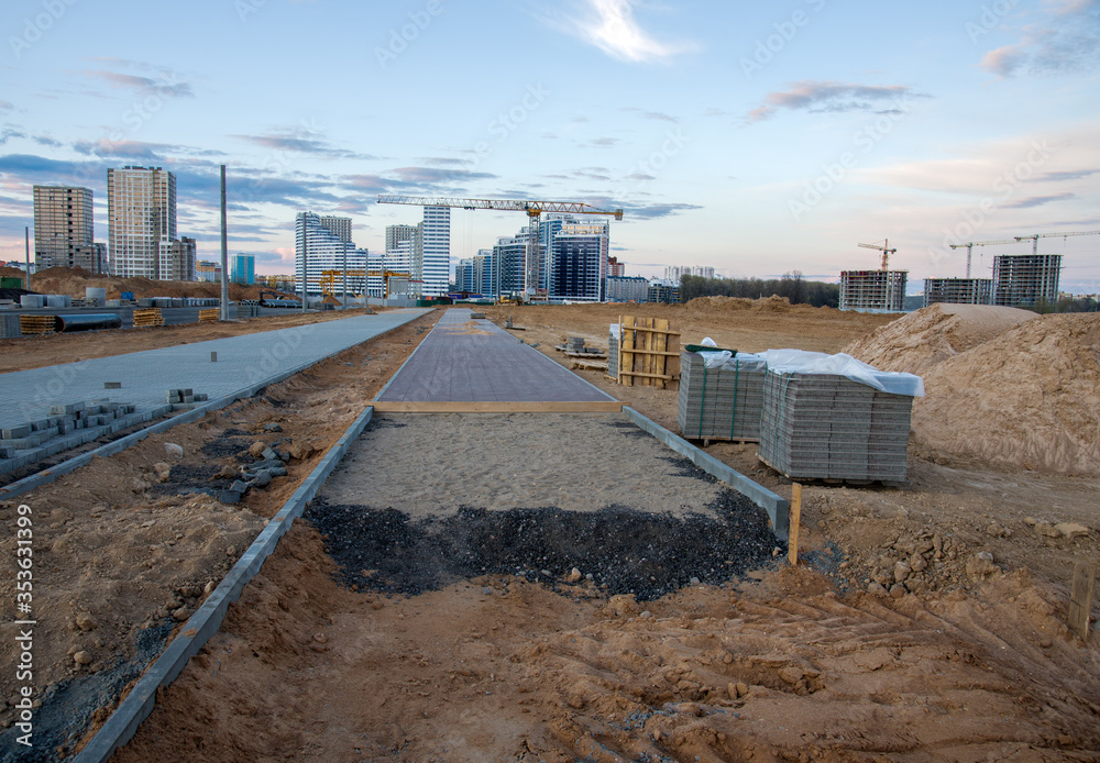 Laying paving slabs and borders at construction site. Process of ...
