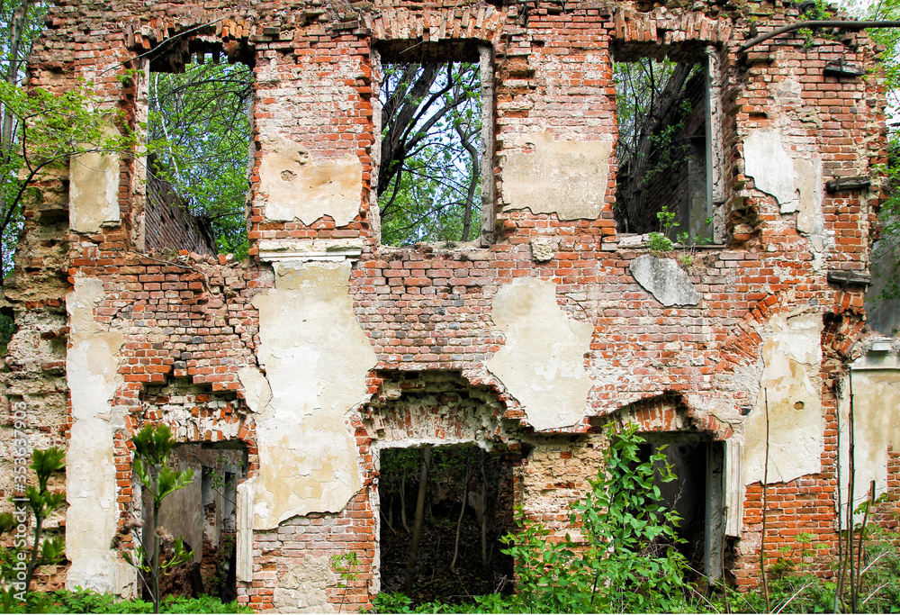 Brick walls of an ancient ruined house. The old facade of a ruined ...