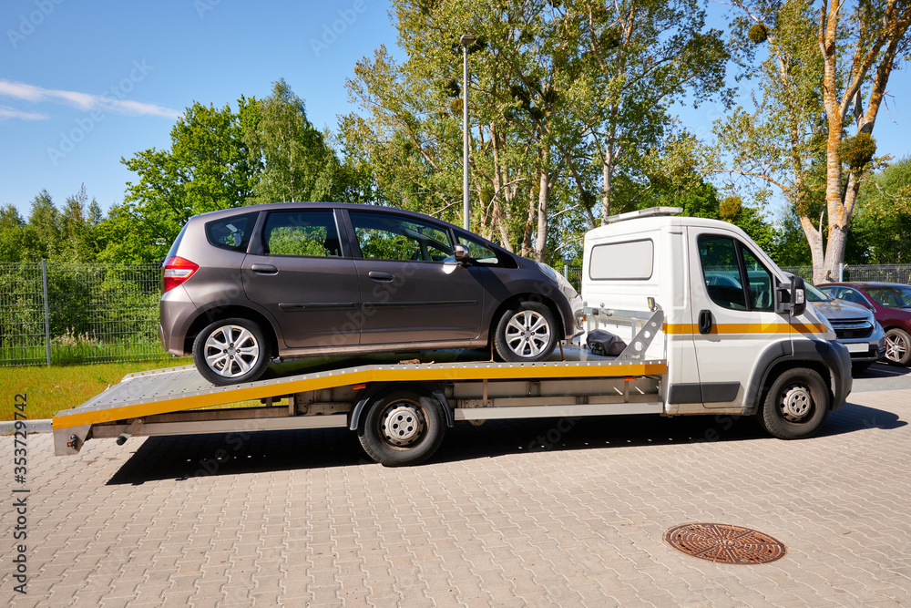 A car on tow truck for emergency car move. Stock Photo | Adobe Stock
