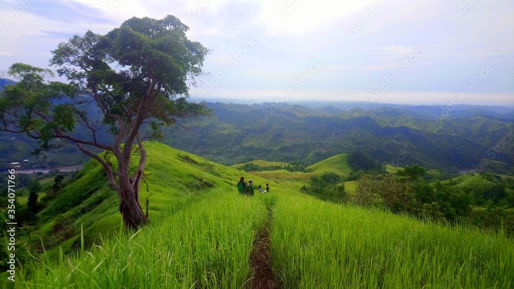 Trek along the vast lush green fields of Mount Megatong in Santo Tomas ...