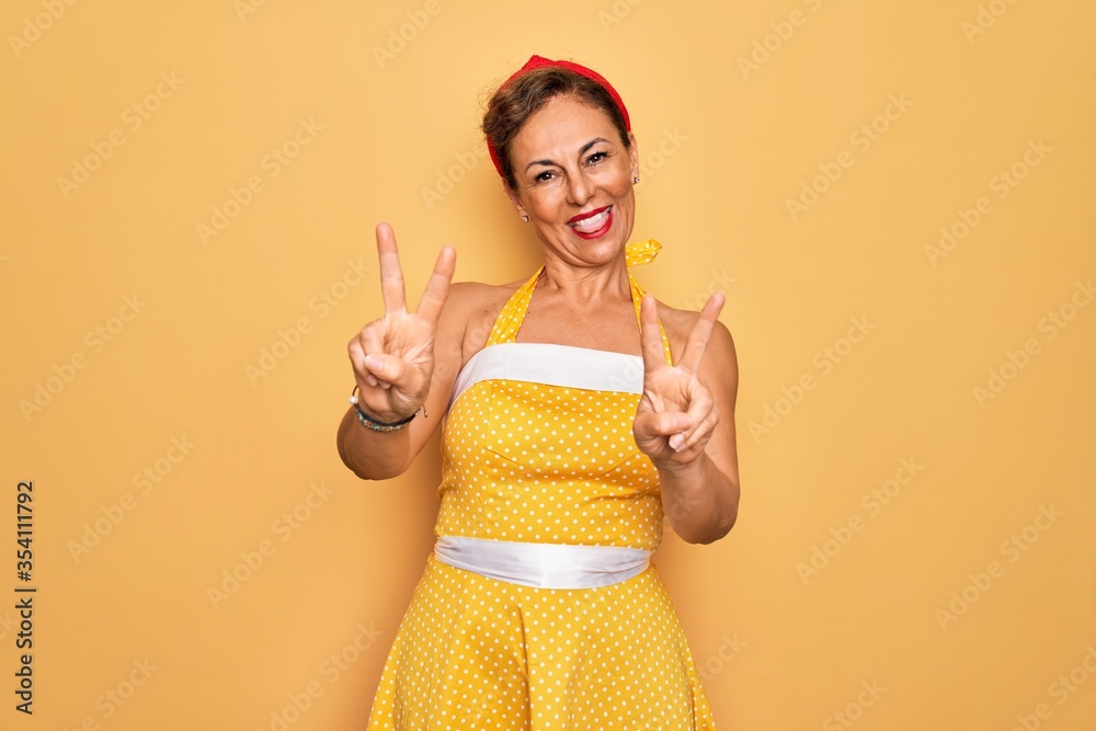 Middle age senior pin up woman wearing 50s style retro dress over ...