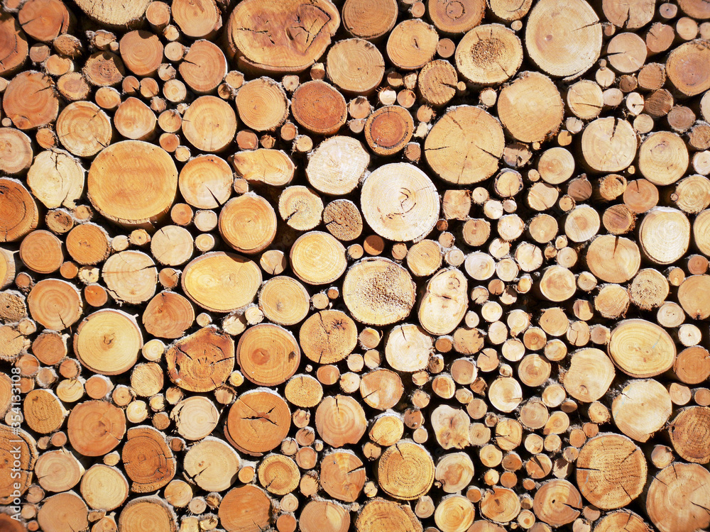 Sawn timber logs stacked for a wood burning stove. Close up in full ...