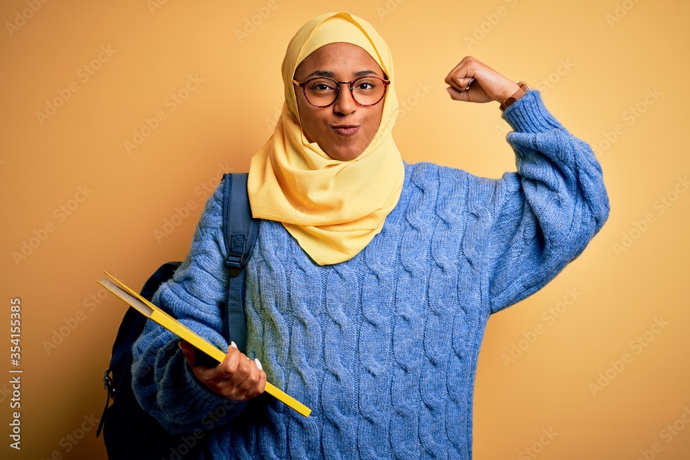 Young African American student woman wearing muslim hijab and backpack ...