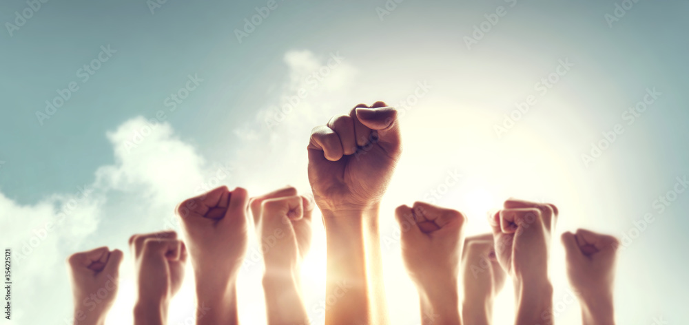 Crowd of protesters people. People raised fist air fighting for their ...