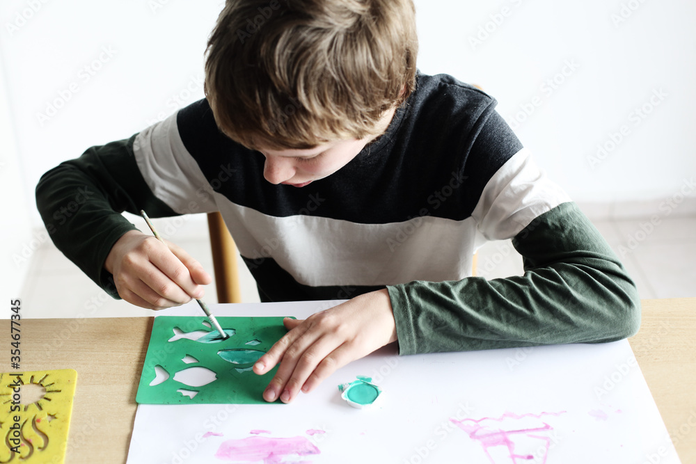 Cute 12 years old autistic boy drawing Stock Photo | Adobe Stock