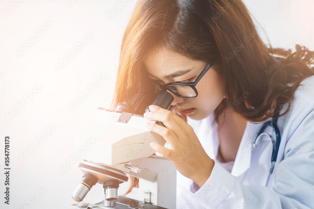 Medical health clinic beautiful Asian doctor using microscope examining ...