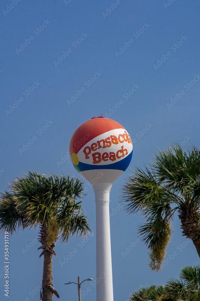 Iconic Pensacola Beach beachball water tower standing above palm trees ...