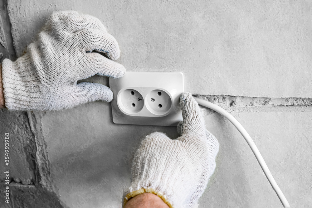 Work on the installation of electrical outlets. The wizard replaces the ...