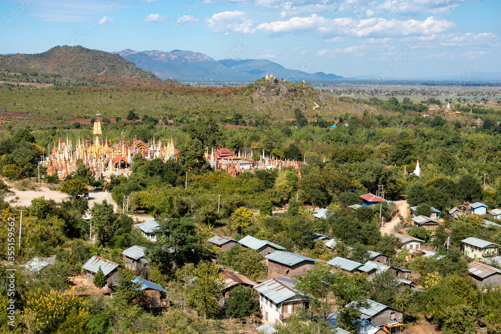 Traditional intha village close to Inle Lake. Group of pagodas and ...