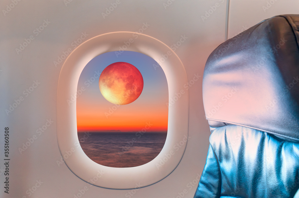 Big blood red moon with - Lunar Eclipseas seen through window of an ...