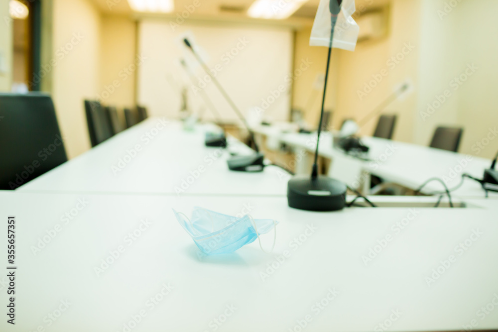Selective focus to mask with blurry microphone in conference room ...