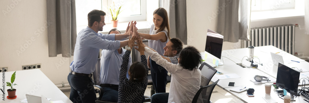 Group of multi ethnic employees gathered in co-working celebrating ...