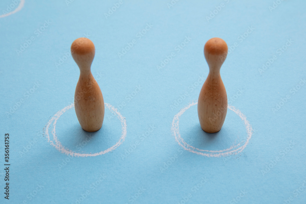 Social distancing concept. Wooden figures stand in white circles Stock ...