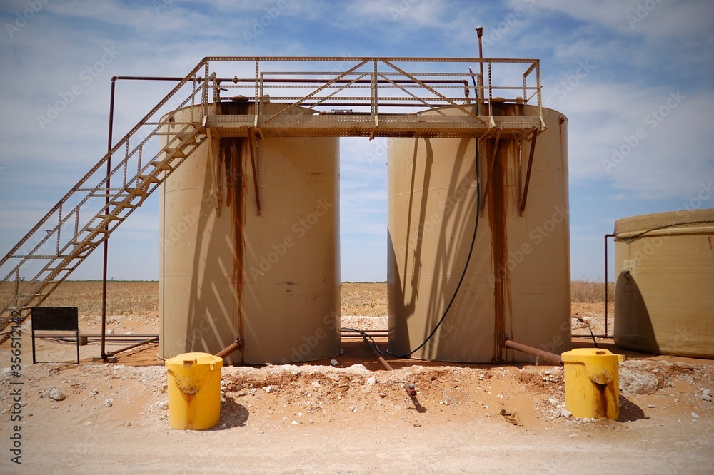 Foto de Stock Crude oil dripping down the side of storage tanks | Adobe ...