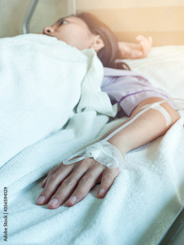 Portrait of tired female patient is lying and sleeping on the patient ...