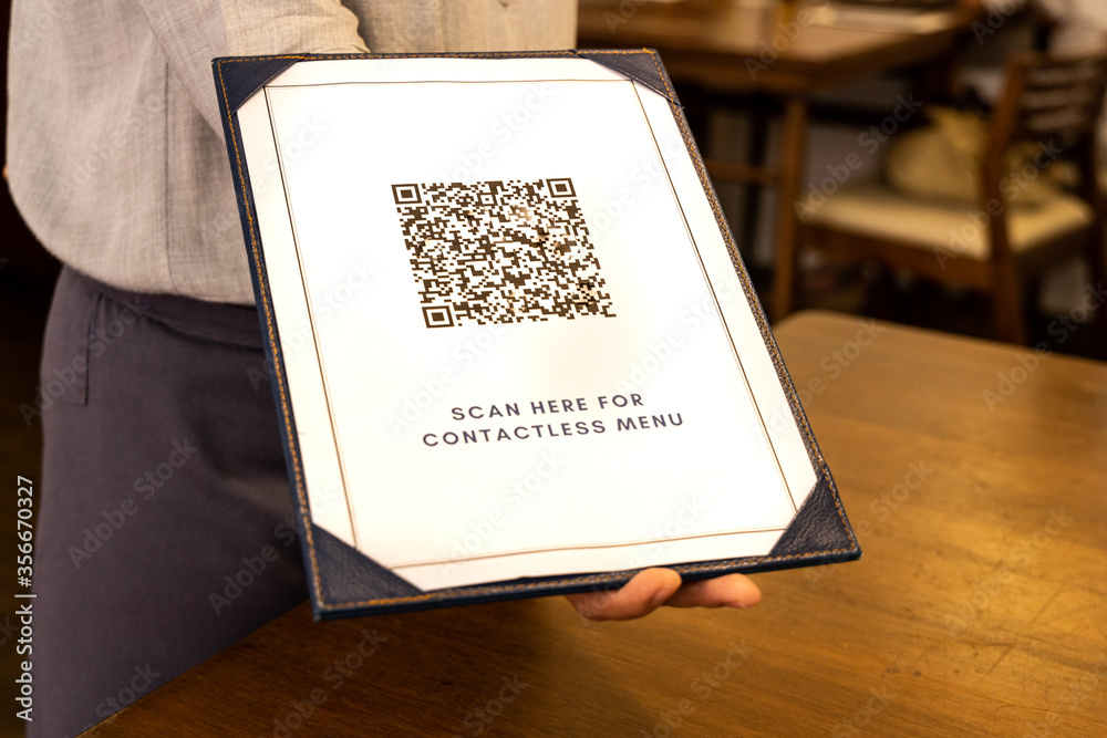 Foto de Stock Waitress display contactless menu with QR code as part of new normal. QR code ...
