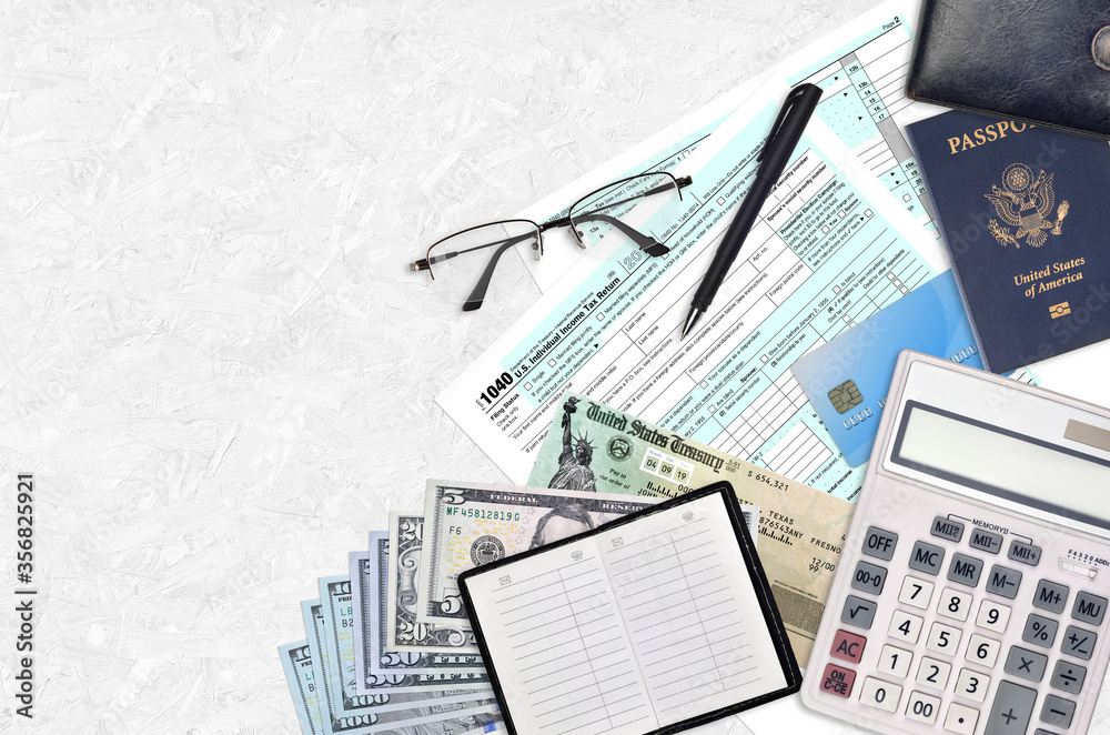 IRS form 1040 U.S. Individual income tax return with refund check lies ...