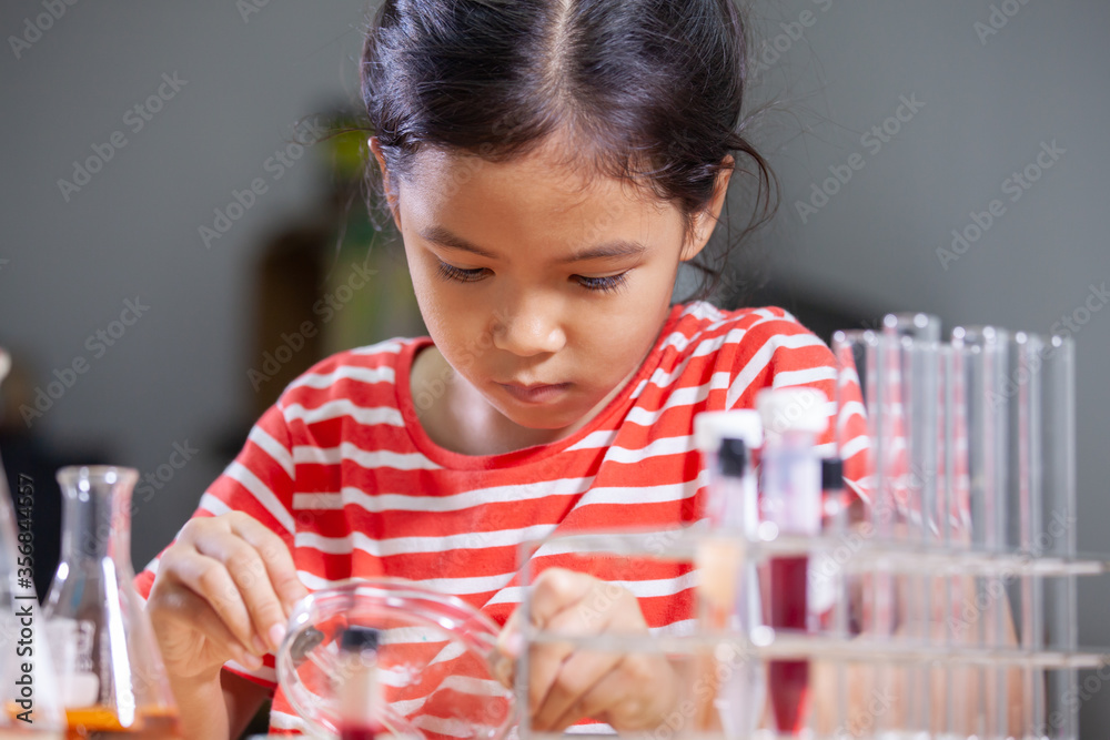 Asian child girl making chemical experiment in the laboratory. Stock ...