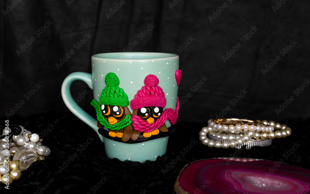 The original mug with decorative figurines made with their own hands. A ...
