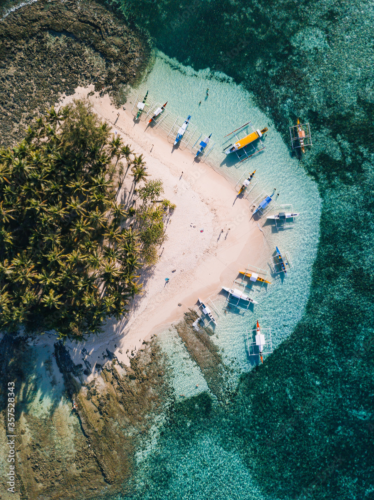 Aerial photos of Guyam Island, a tear-drop shaped island in the ...
