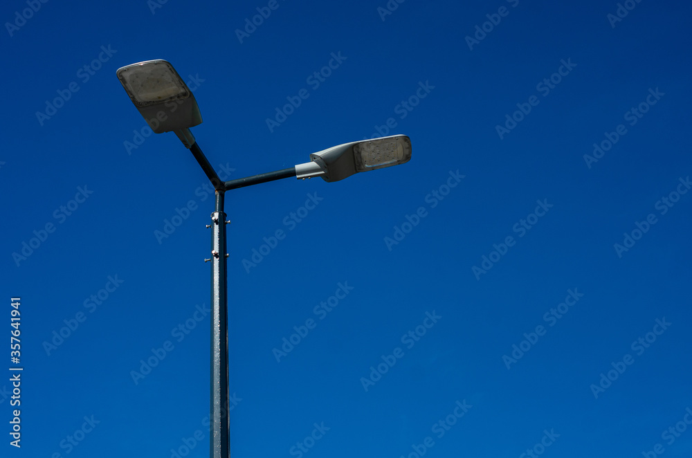 A modern street LED lighting pole. Urban electro-energy technologies ...