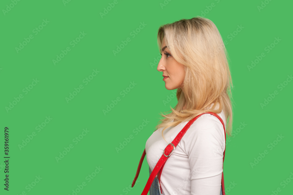 Side view of serious concentrated adult woman with blond hair in ...