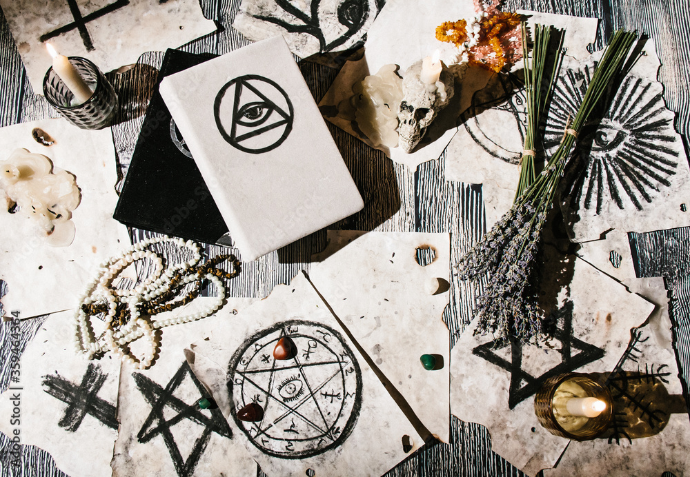 White magic book laying on the table with old manuscripts with occult ...