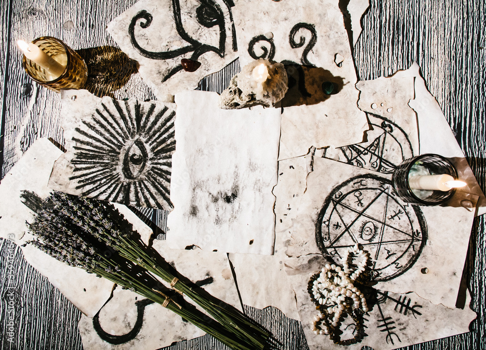 old manuscripts with occult symbols, candles, lavender. Concept of ...