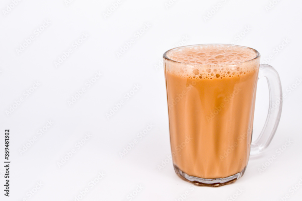 Teh tarik or pulled tea is a famous sweet milk tea in Malaysia. Bubble is floating on the ...
