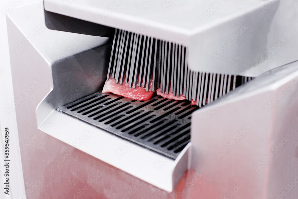 Closeup of a fresh, raw cuts of minced meat, introduced into an ...