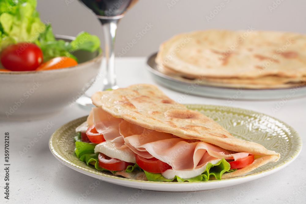 Italian flat bread - piadina romagnola, stuffed with italian ham ...