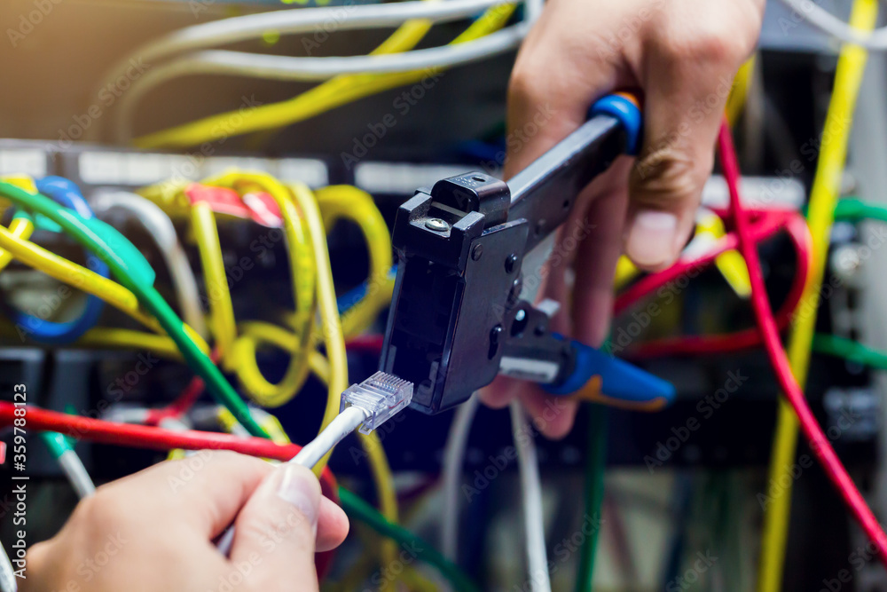 Selective focus to RJ45 Connector with crimping RJ45 tool on blurry ...