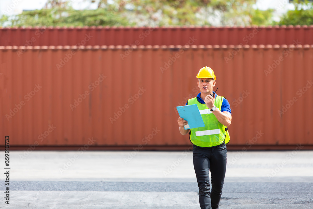 foreman maneger working through a radio communication with the workers ...