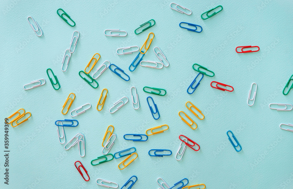Multi-colored paper clips located randomly throughout the picture ...