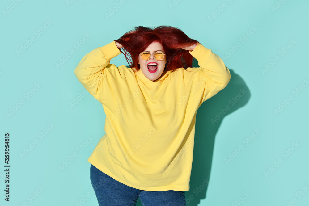 Cute young woman with overweight smiling joyfully running fingers ...