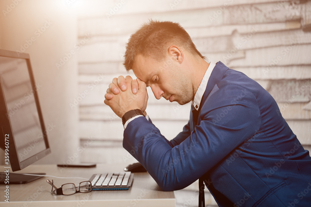 Tired business man at workplace in office holding his head on hands ...