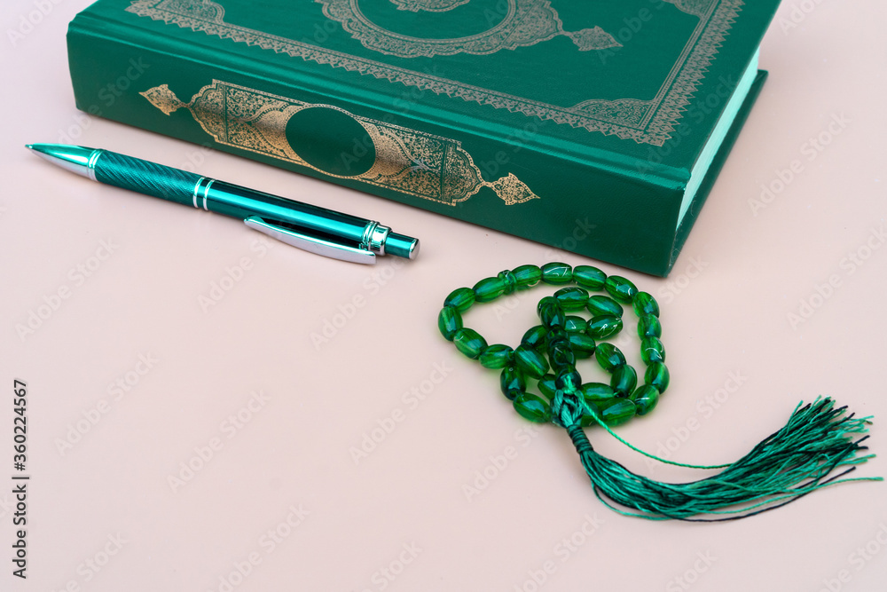 Muslim islamic faith concept Koran book , green pen for writing, green ...
