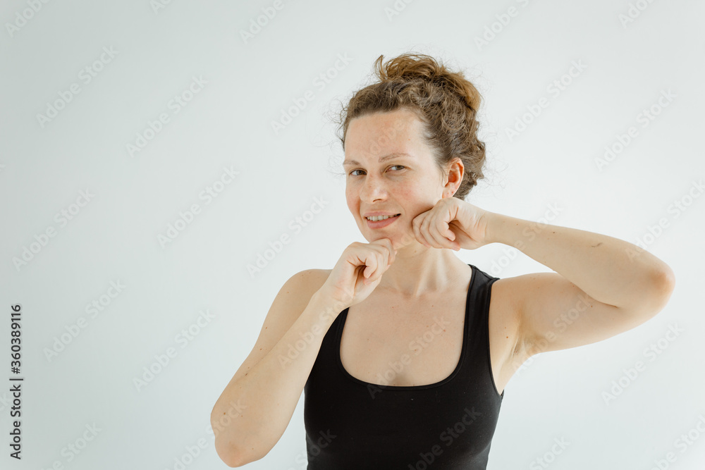 Cute Caucasian girl performing yoga exercises for the face. Complex for ...